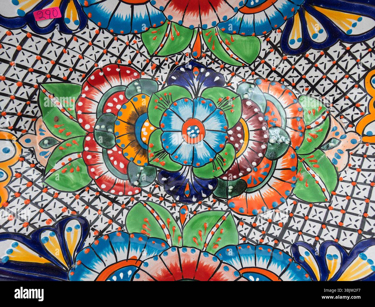 Colorful Talavera crafts showcase intricate floral patterns typical of Mexican artistry. This ...