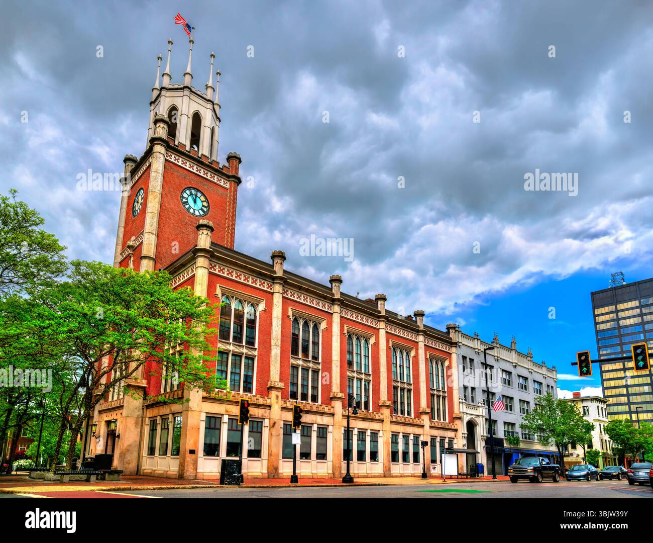 Under dramatic clouds, the red brick Manchester City Hall stands on Elm ...