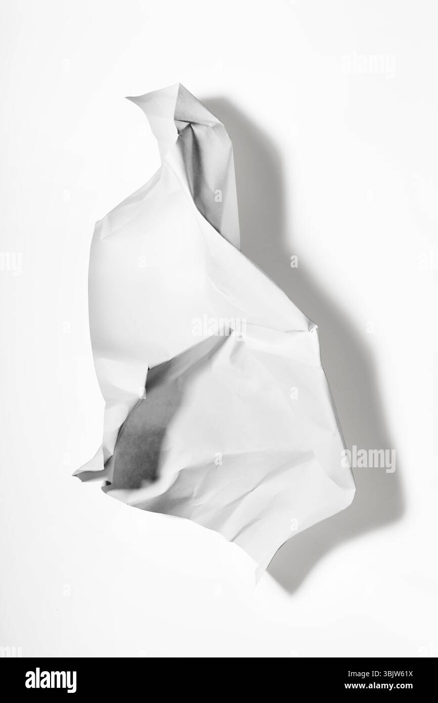 Crumpled white paper casting a bold shadow on white background Stock ...