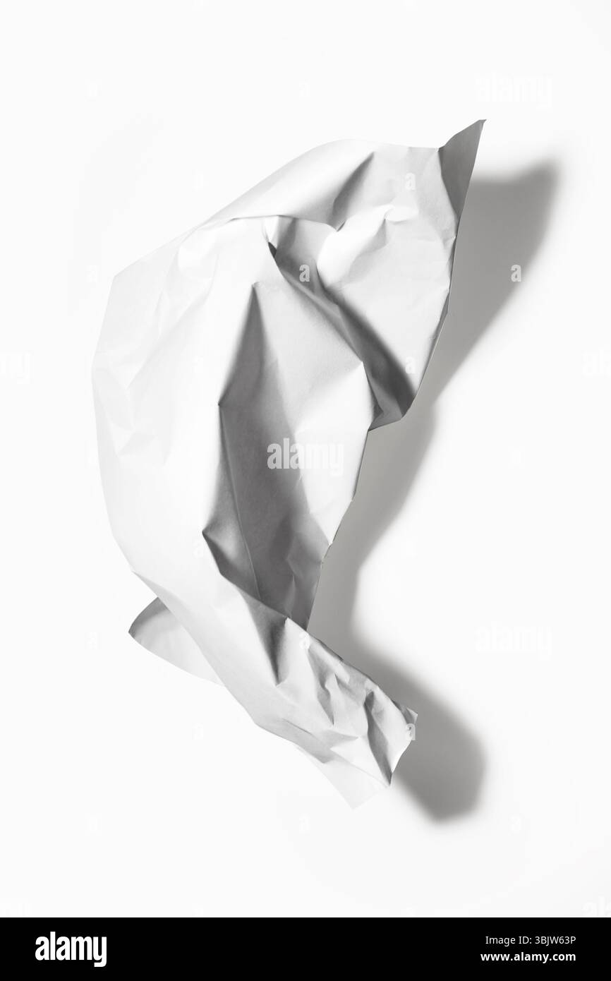 Crumpled white paper casting a bold shadow on white background Stock ...