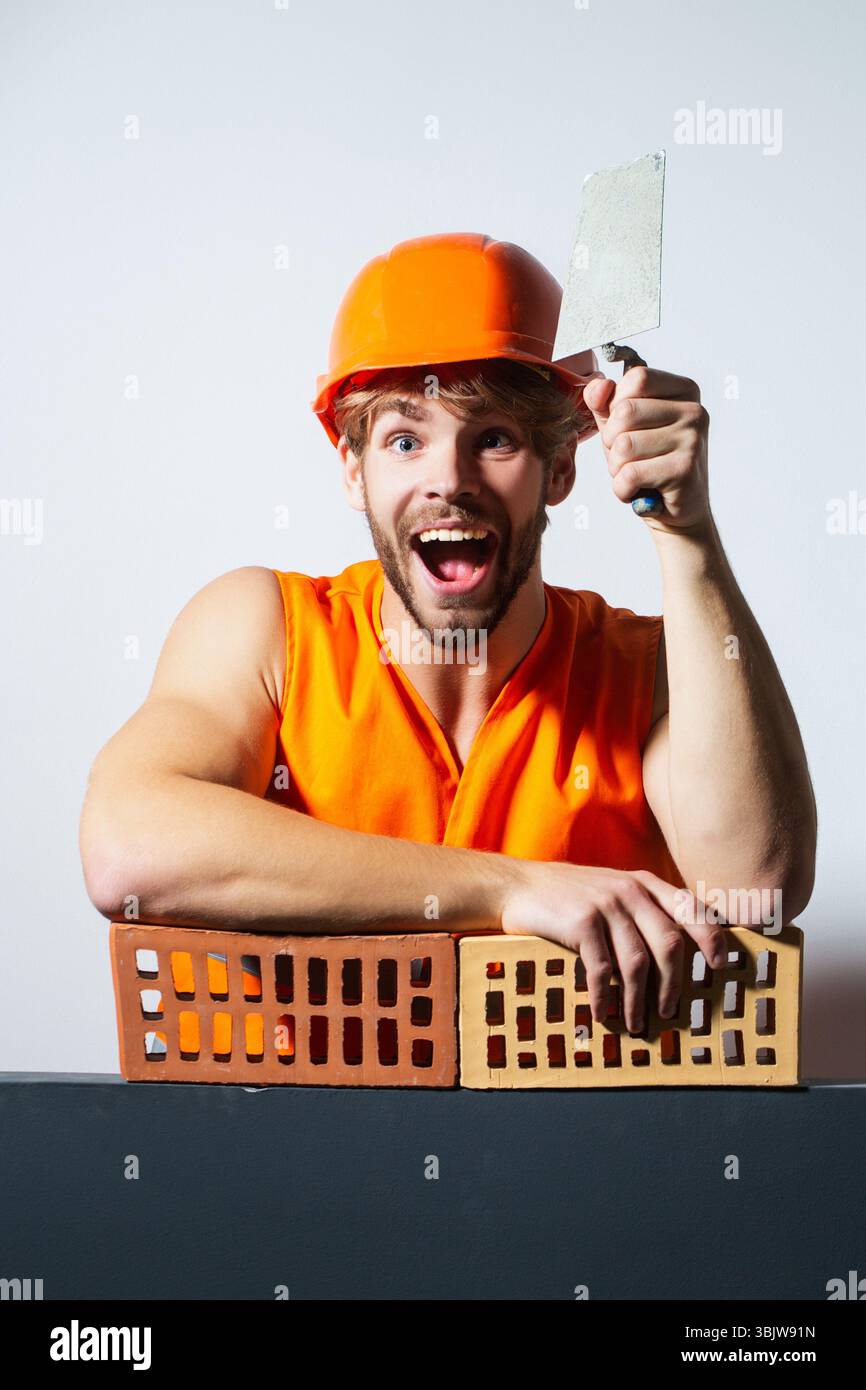 Crazy builder with bricks, funny sale on construction site. Funny man ...