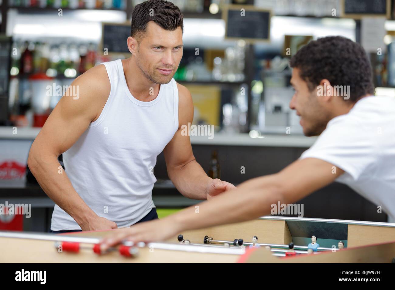 two men playing table football Stock Photo - Alamy