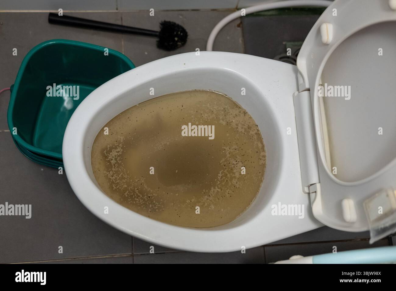 Clogged toilet caused by pouring cat litter into the toilet Stock Photo ...