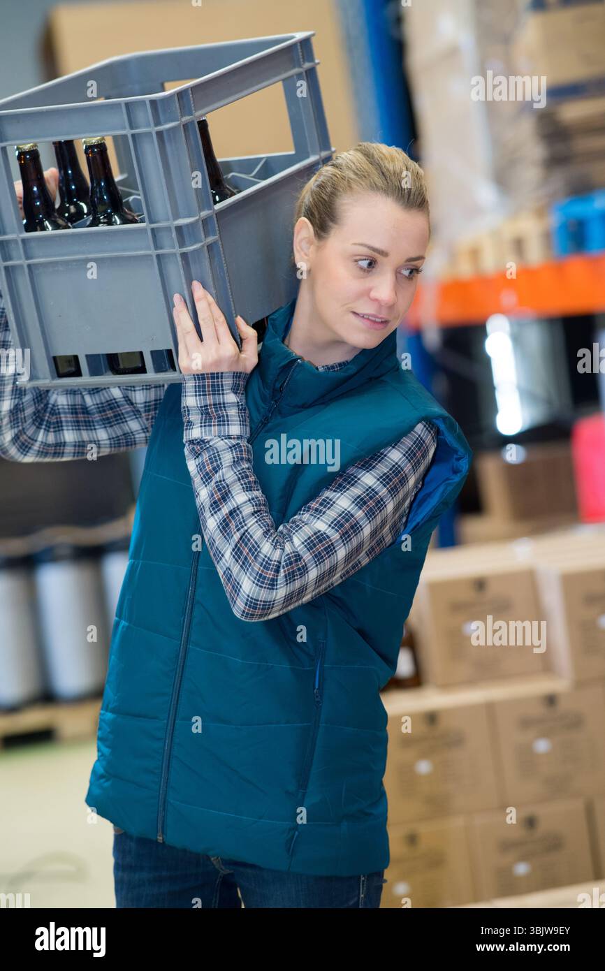 woman carrying crate of beer on her shoulder Stock Photo - Alamy
