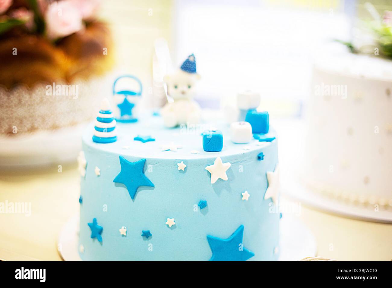 sponge cake with blue mastic and a sweet teddy bear on top. children's ...