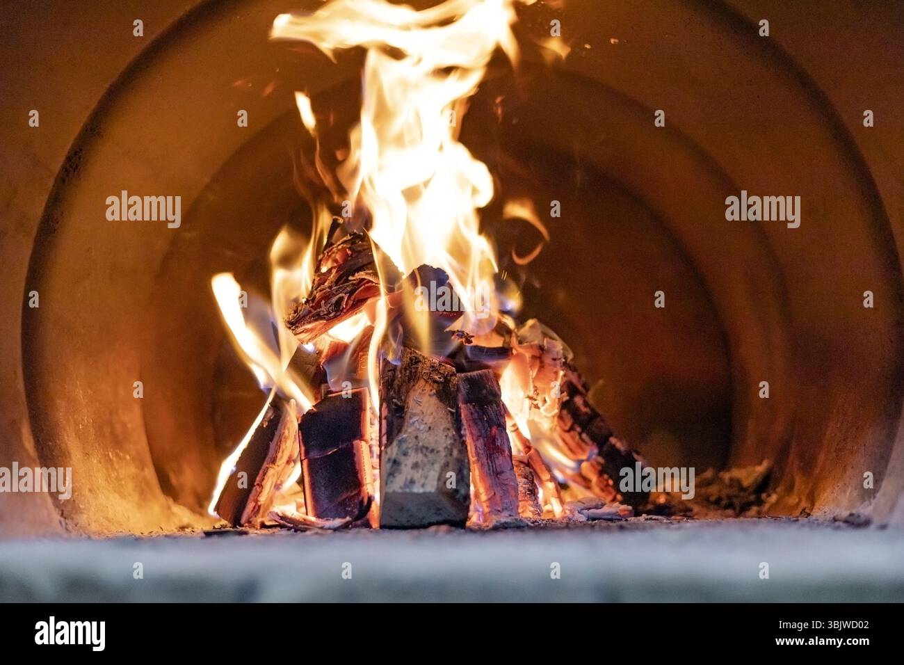 Firewood burns fire in oven hi-res stock photography and images - Alamy