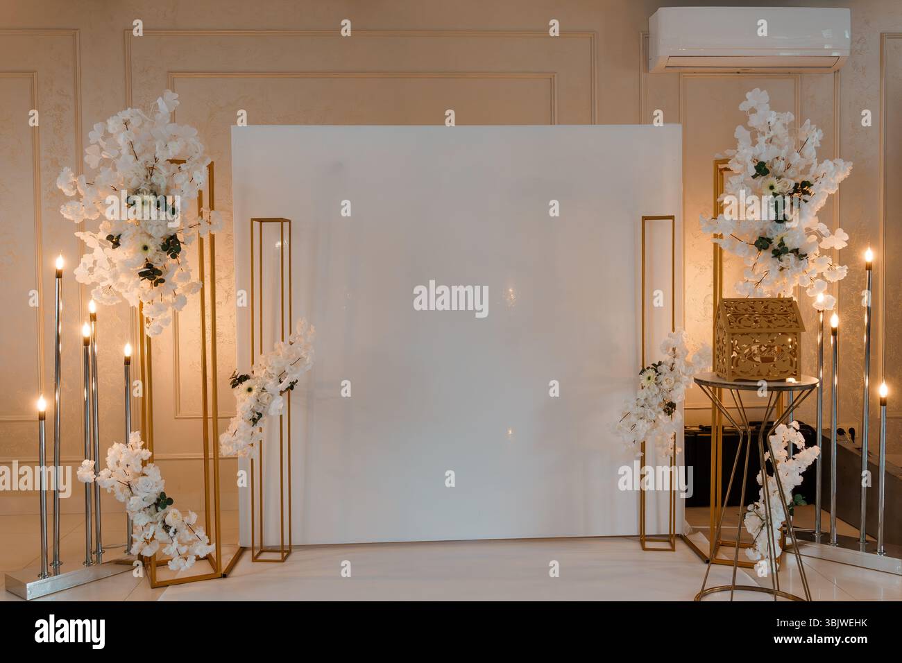 Luxurious wedding stage decoration featuring white flowers, gold metal ...