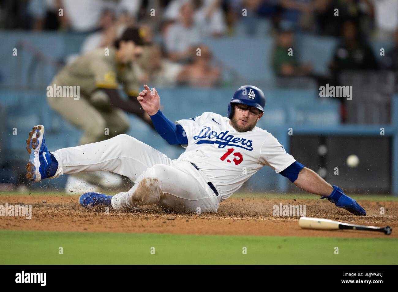 Los Angeles Dodgers' Max Muncy slides to score on an RBI single by ...