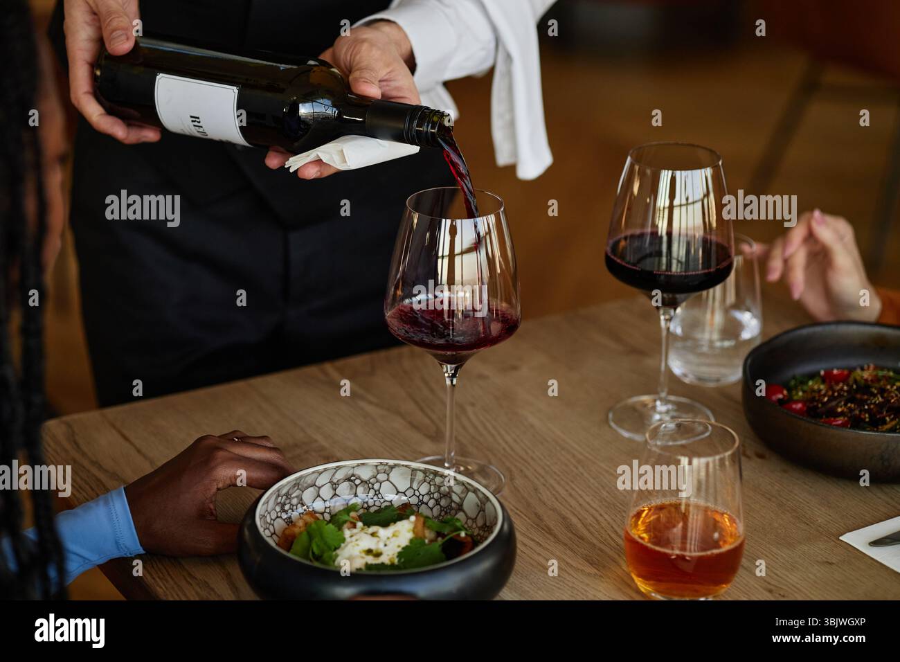 Pouring wine diverse female hi-res stock photography and images - Alamy