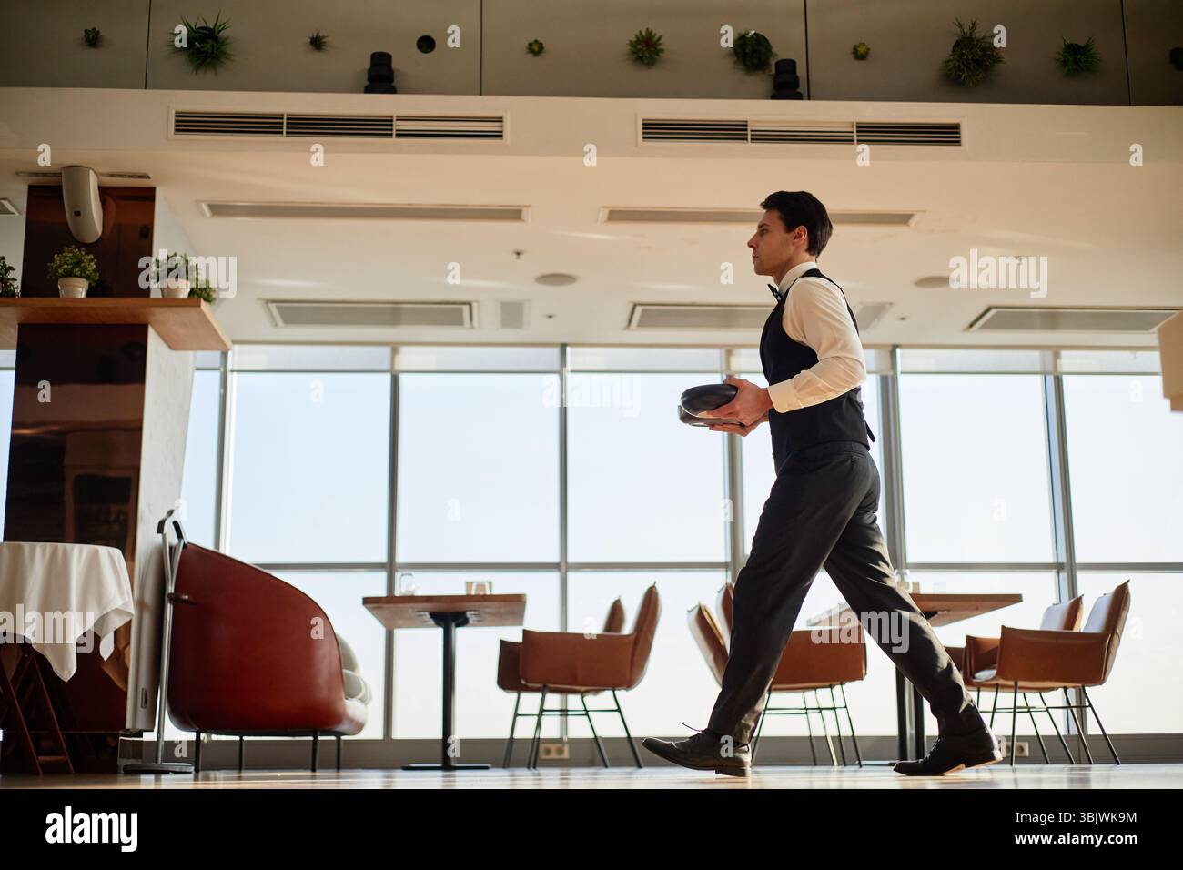 Male carrying tray hi-res stock photography and images - Alamy