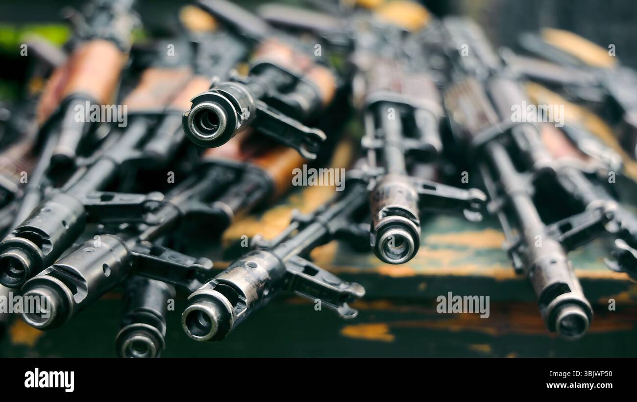 Close-up of stacked rifles ready for use. A detailed view of several ...