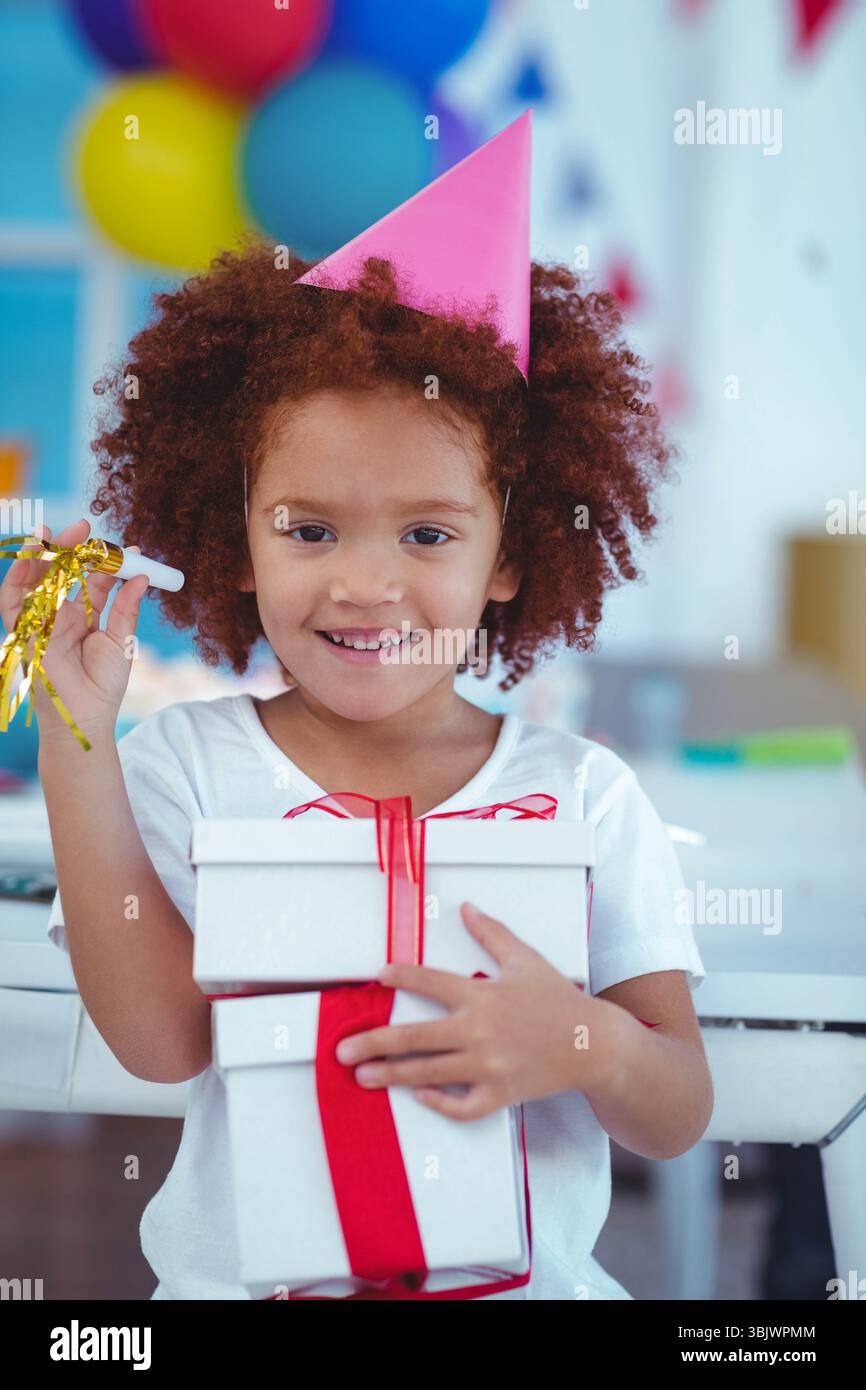White gift boxes sitting near party blower, colorful balloons ...