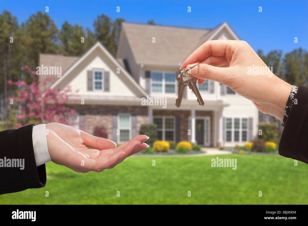 Agent Handing Over the House Keys in Front of New Home Stock Photo - Alamy