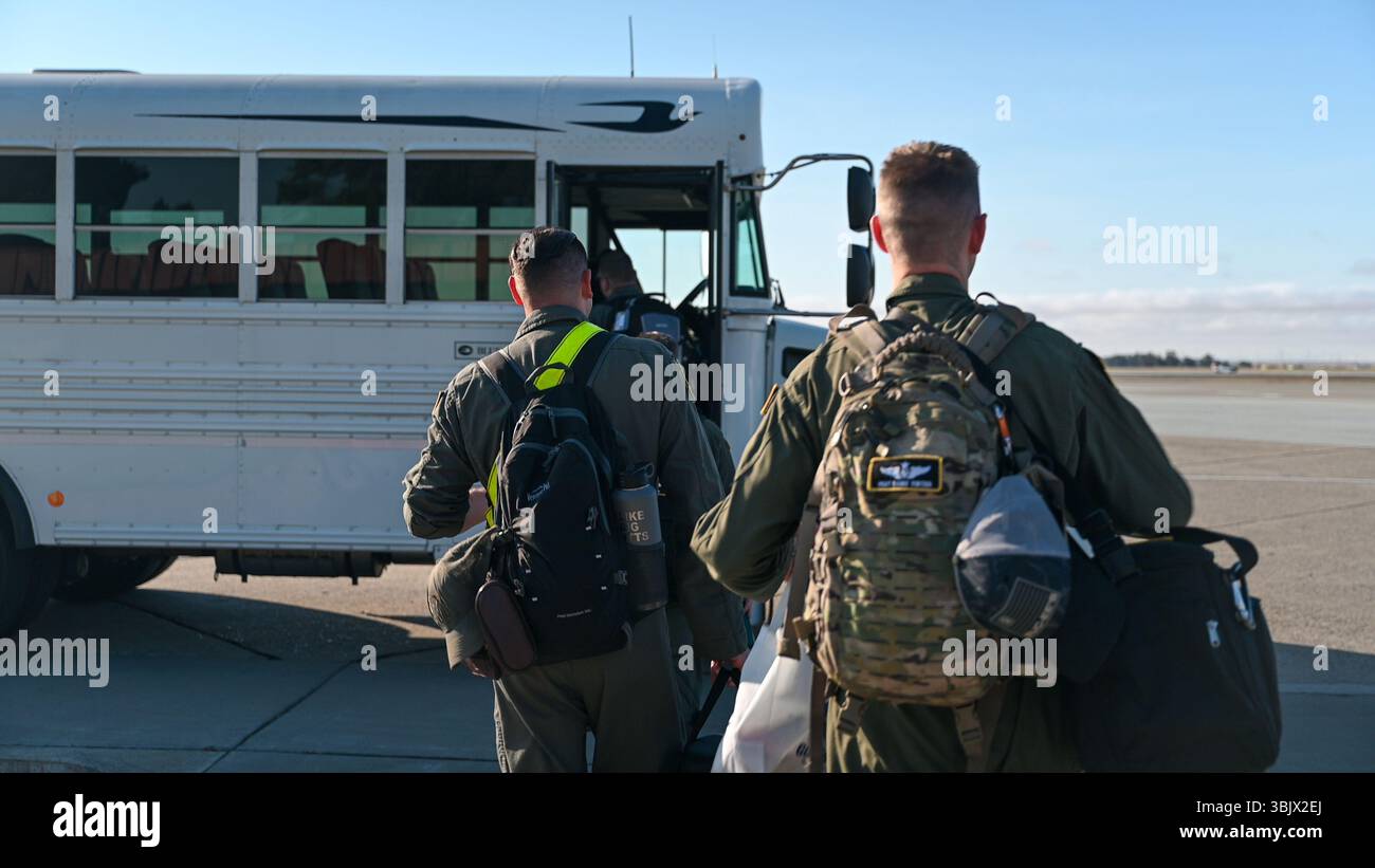 The aircrew of a KC-46A Pegasus board a bus on the flight line to be ...