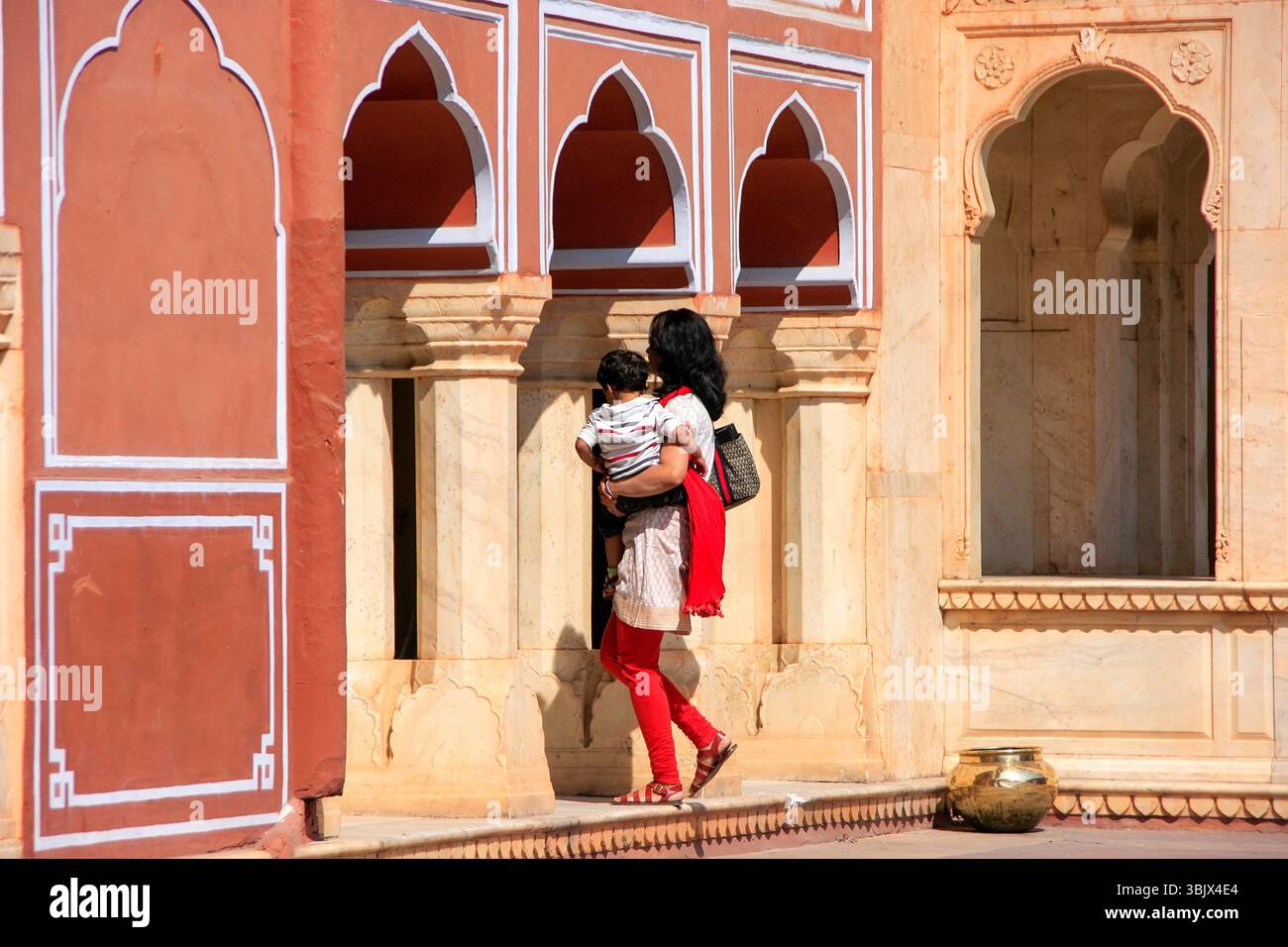 Woman with a child walking at Chandra Mahal in Jaipur City Palace ...