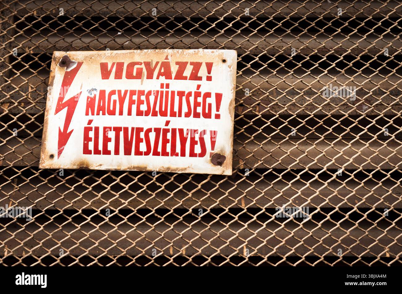High voltage sign on rusty fence Stock Photo - Alamy