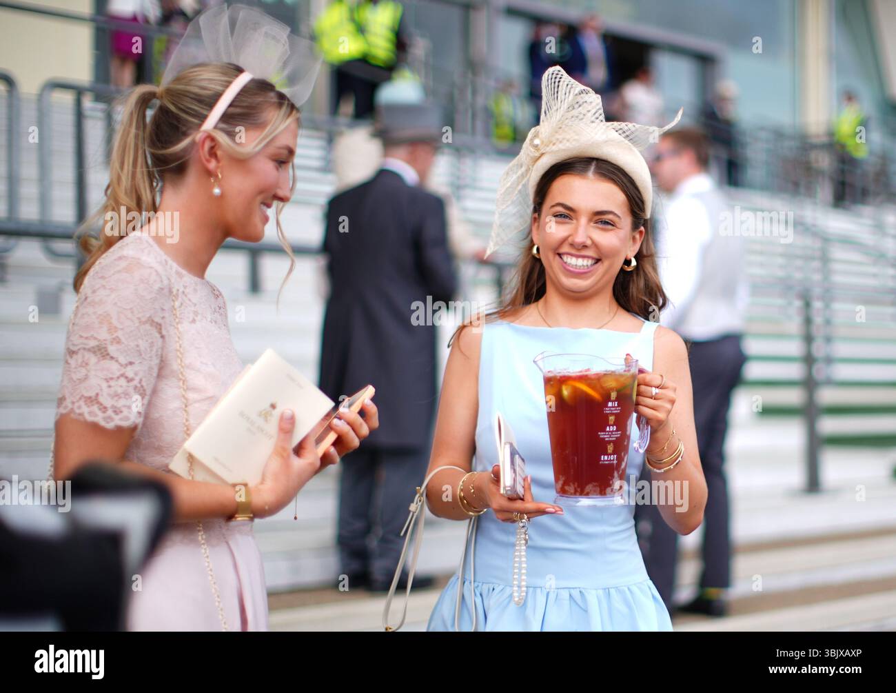 A racegoer holds up a pitcher towards the camera during day one of ...