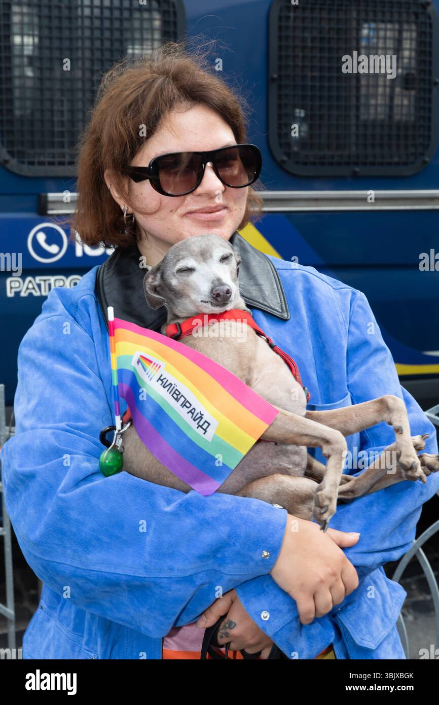June 14, 2025, Kyiv, Ukraine: A woman with sunglasses holds a dog with ...