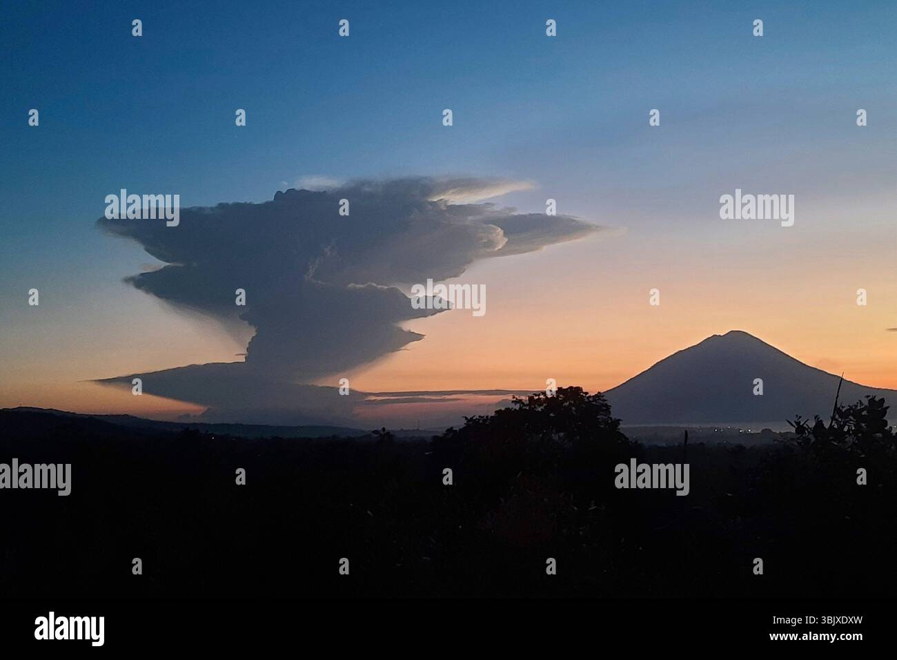 Volcanic smoke billows from Mount Lewotobi Laki-Laki during an eruption ...