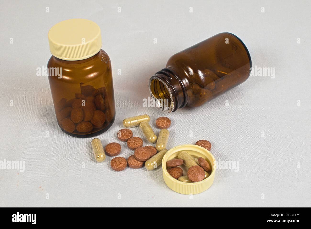 Tablet and capsule forms of supplements are displayed next to two pill ...