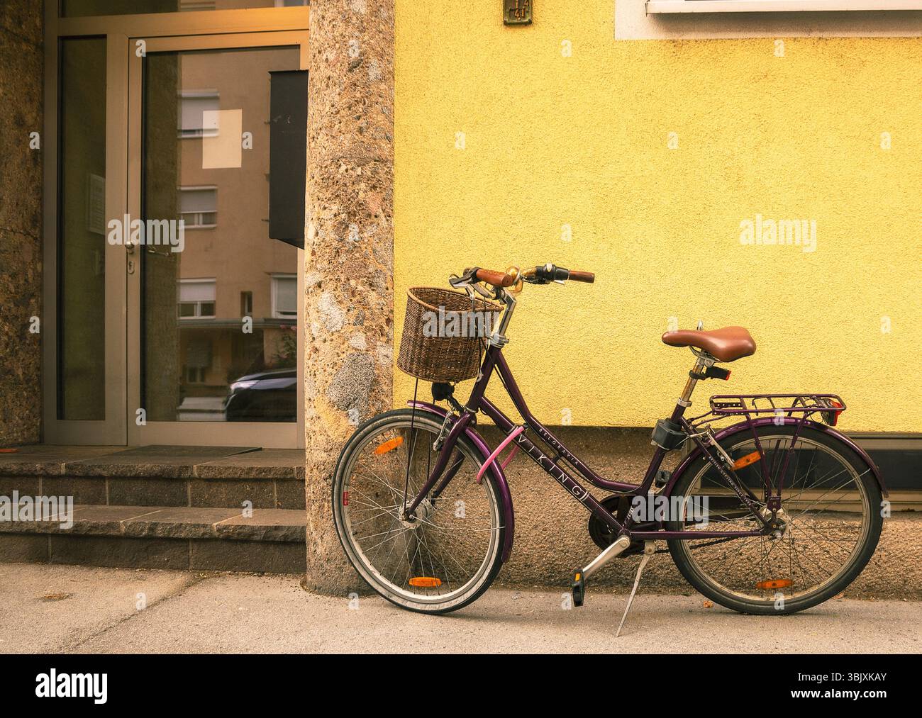 Colorful urban scene: Retro bike resting near residential doorway and ...