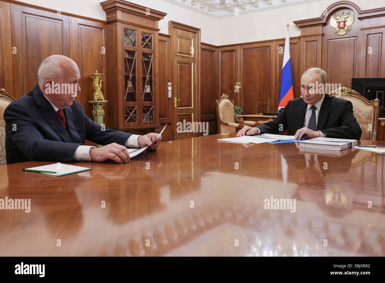 Russian President Vladimir Putin, right, listens to Rostec State ...