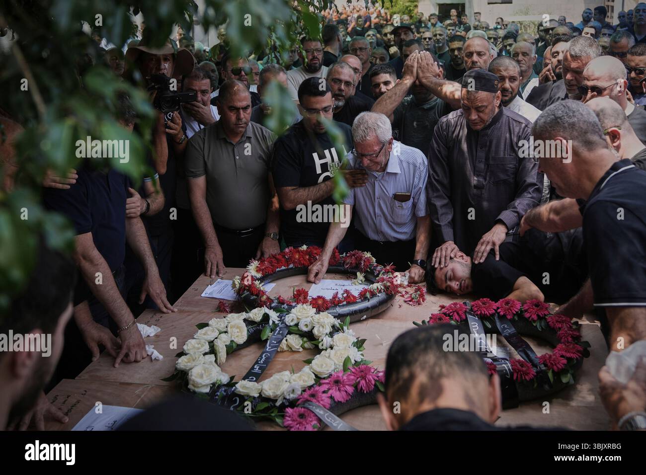 Relatives attend the funeral of four members of the Khatib family ...