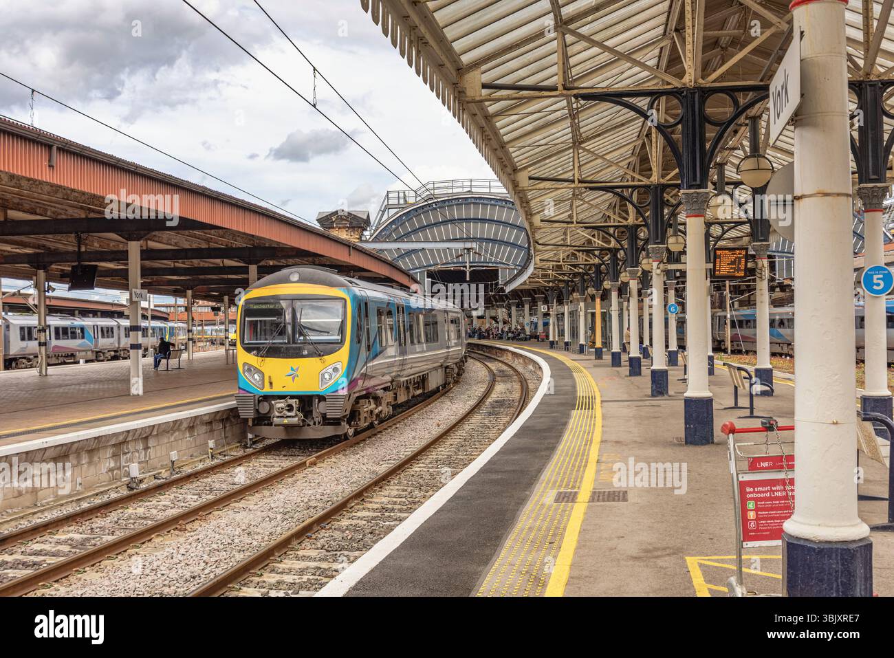 A locomotive and train departs a railway station. A historic 19th ...