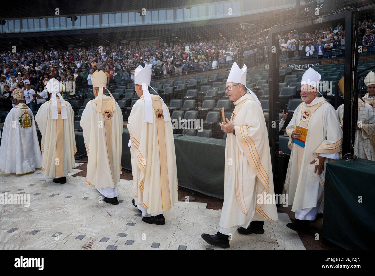 Priests enter the field for a mass during the Archdiocese of Chicago's ...