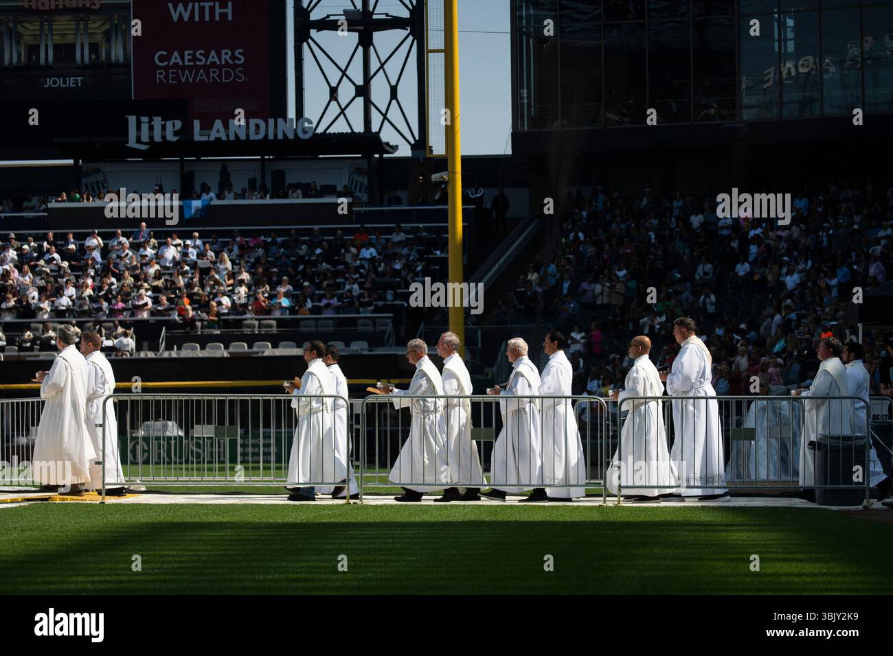 People enter the field for a mass during the Archdiocese of Chicago's ...