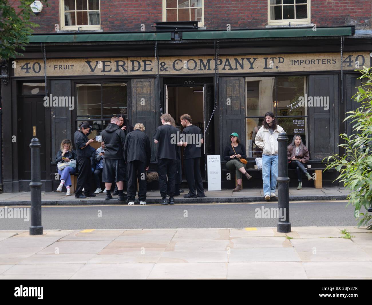 Coffee drinkers congregate outside the historic Verde & Company shop ...
