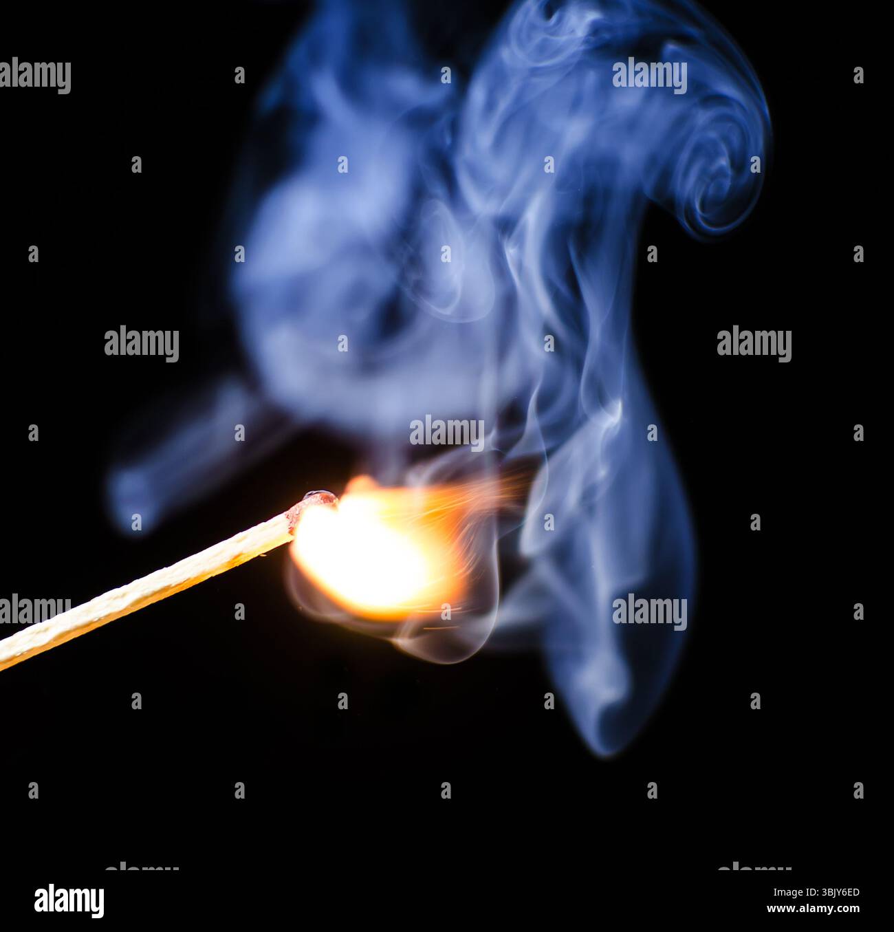Match ignition with smoke over black background Stock Photo - Alamy