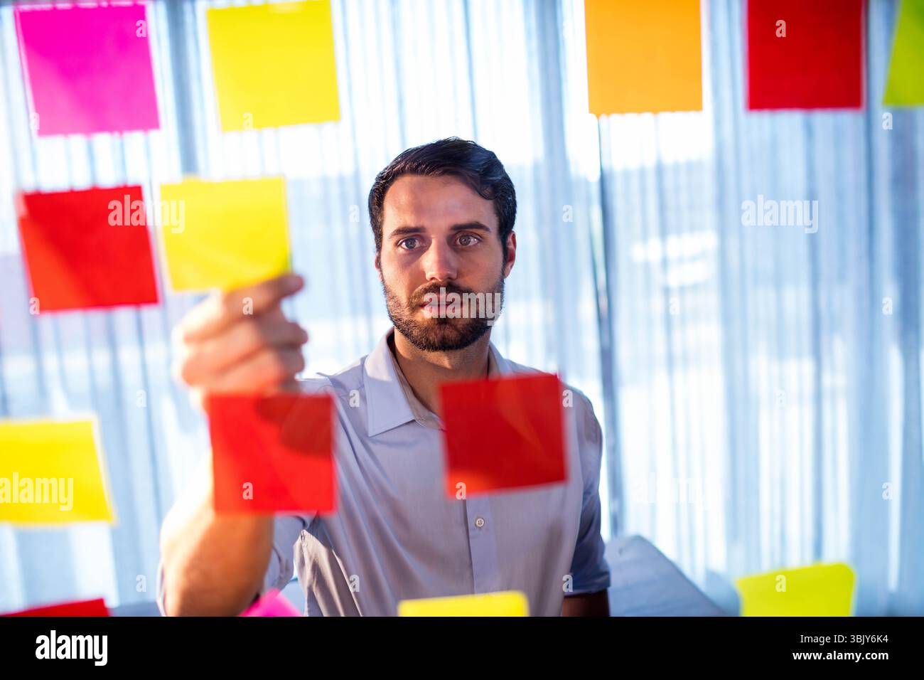 Person placing yellow sticky note hi-res stock photography and images ...
