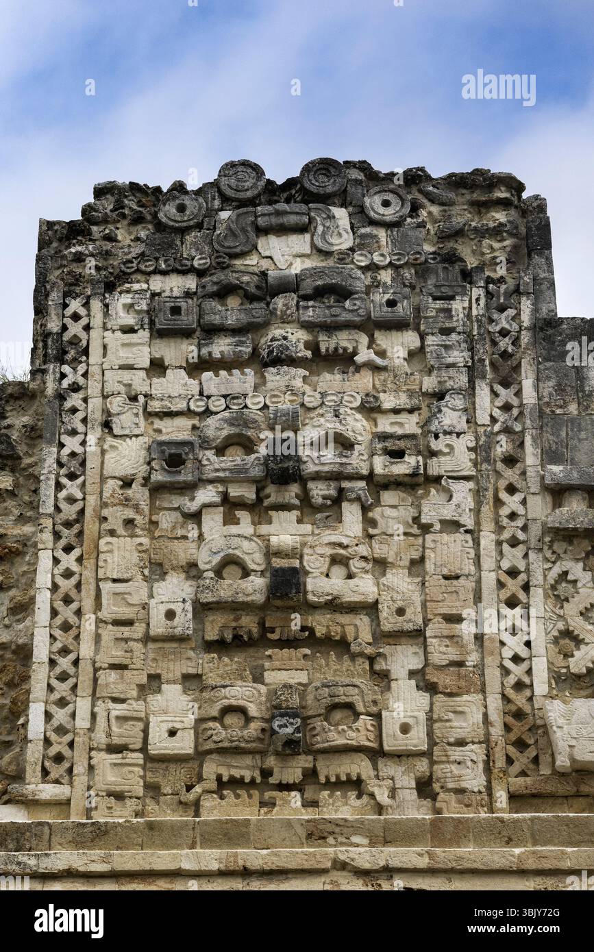Maya Nunnery building with elaborate stone masks and carved serpent ...