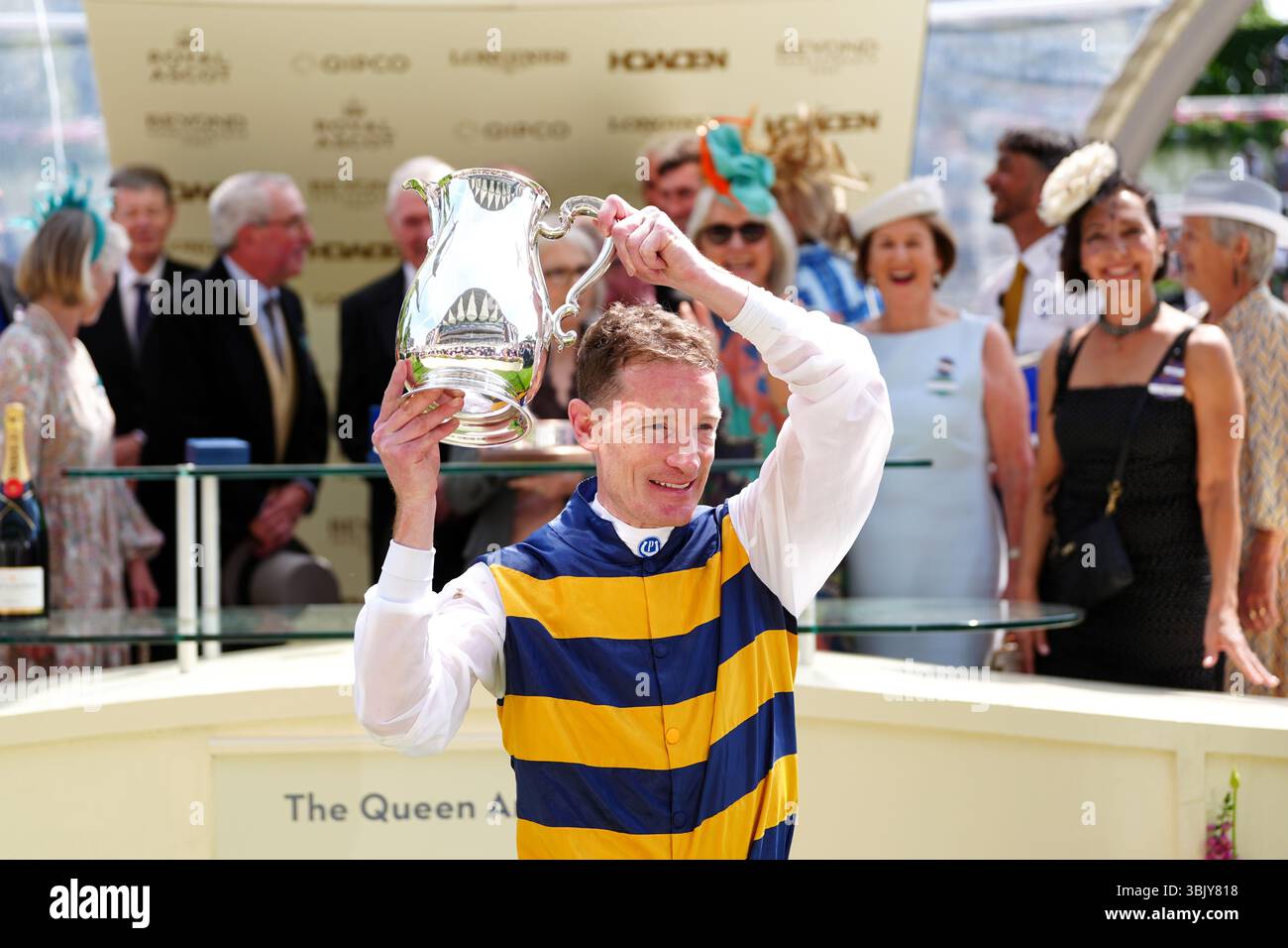 Mark Zahra lifts the Queen Anne Stakes trophy after winning the Queen ...