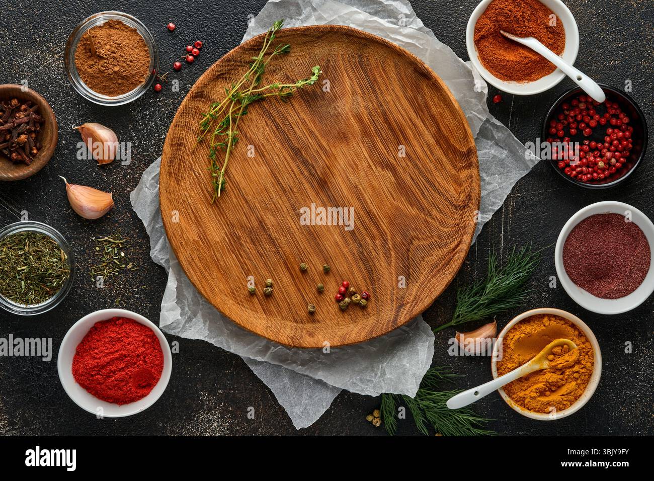 Set of Indian fragrant spices and herbs on a black stone background ...