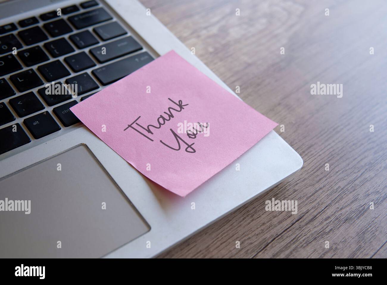 A sticky note with "Thank You" on the corner of a laptop. Gratitude ...