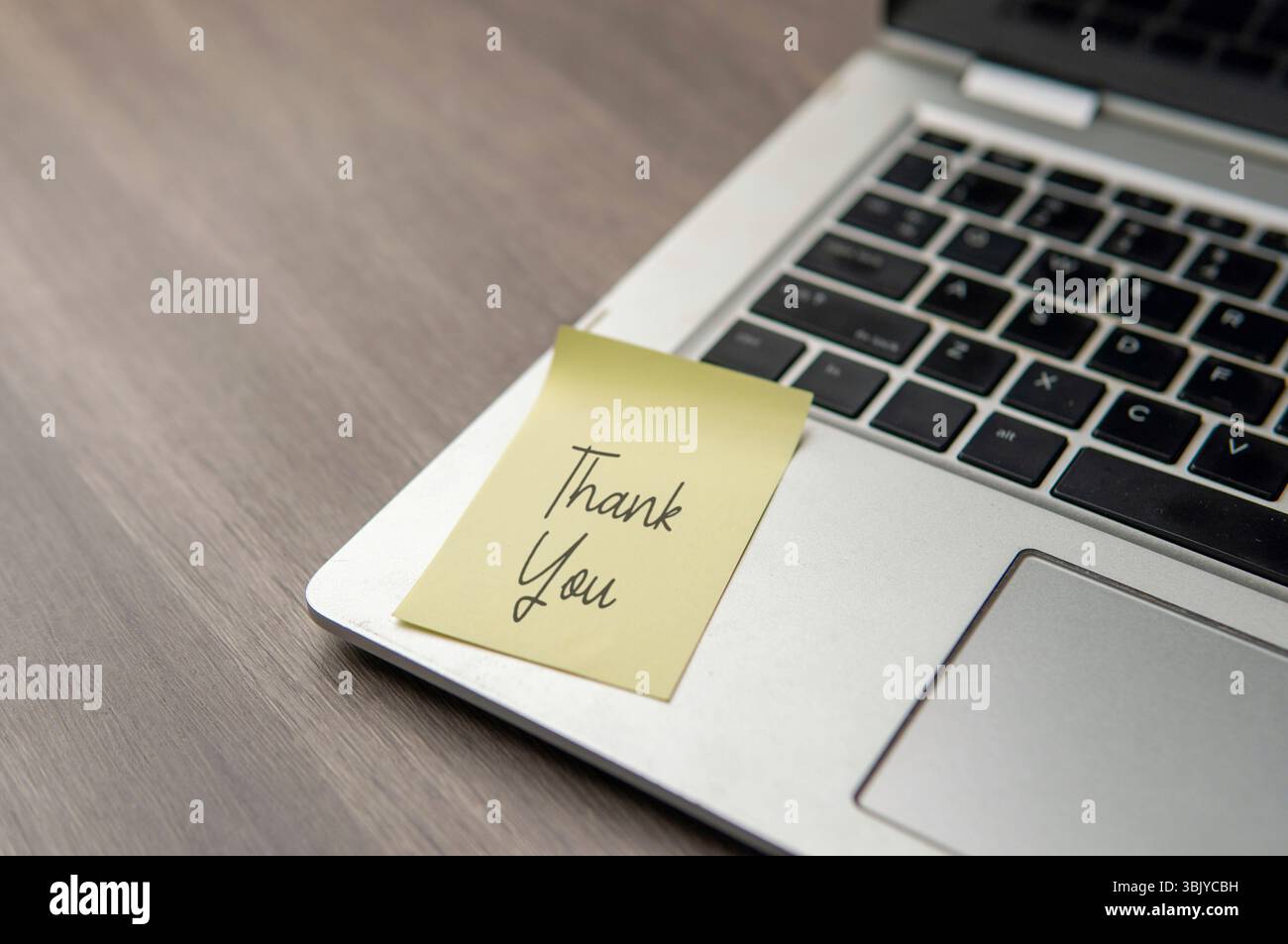 A sticky note with "Thank You" on the corner of a laptop. Gratitude ...