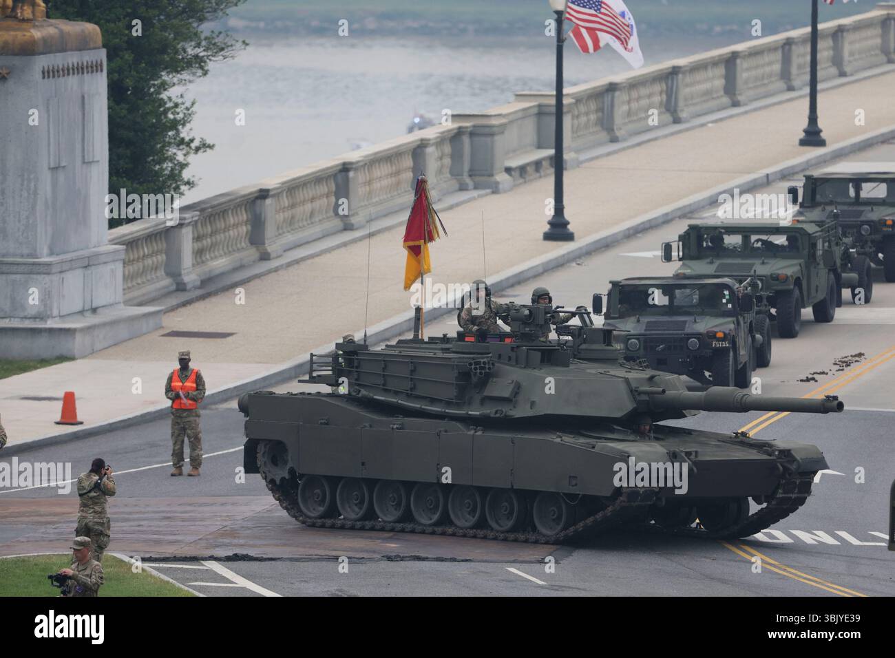 Military vehicles cross over the Arlington Memorial Bridge during a ...