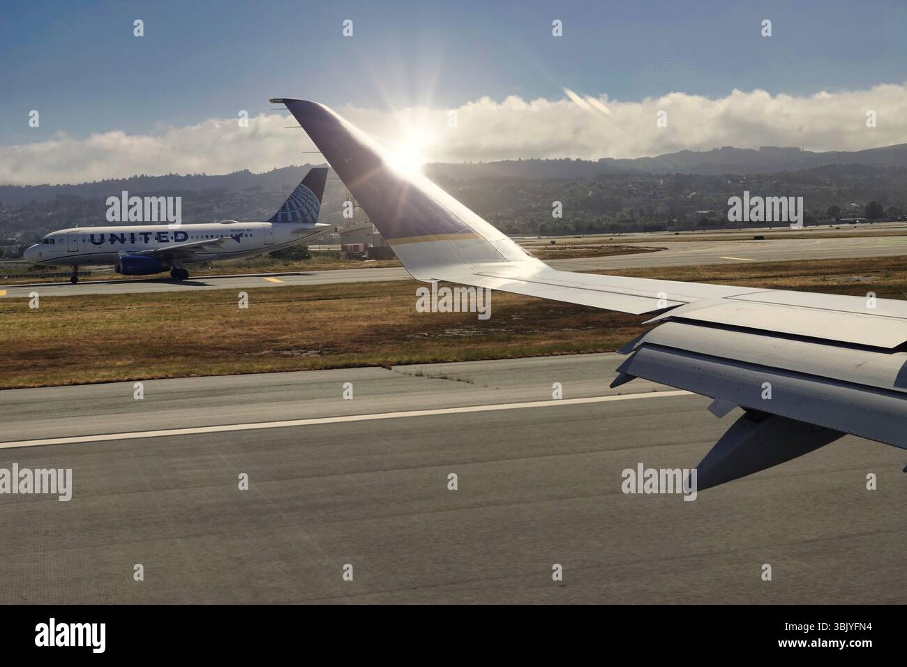 SFO - 7th May, 2025 Sun glints off landing aircraft wing tip as sister ...