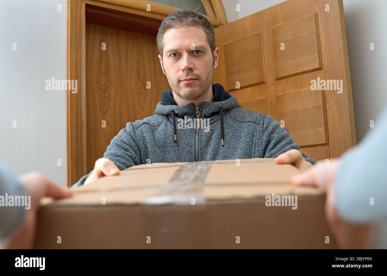 Male courier delivers package. Parcel delivery service Stock Photo - Alamy