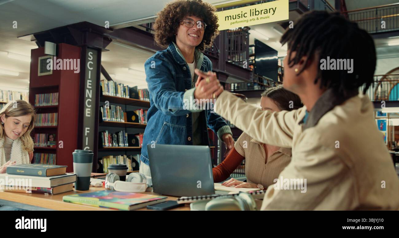 Group, handshake and college with friends in library for education, welcome and student life ...