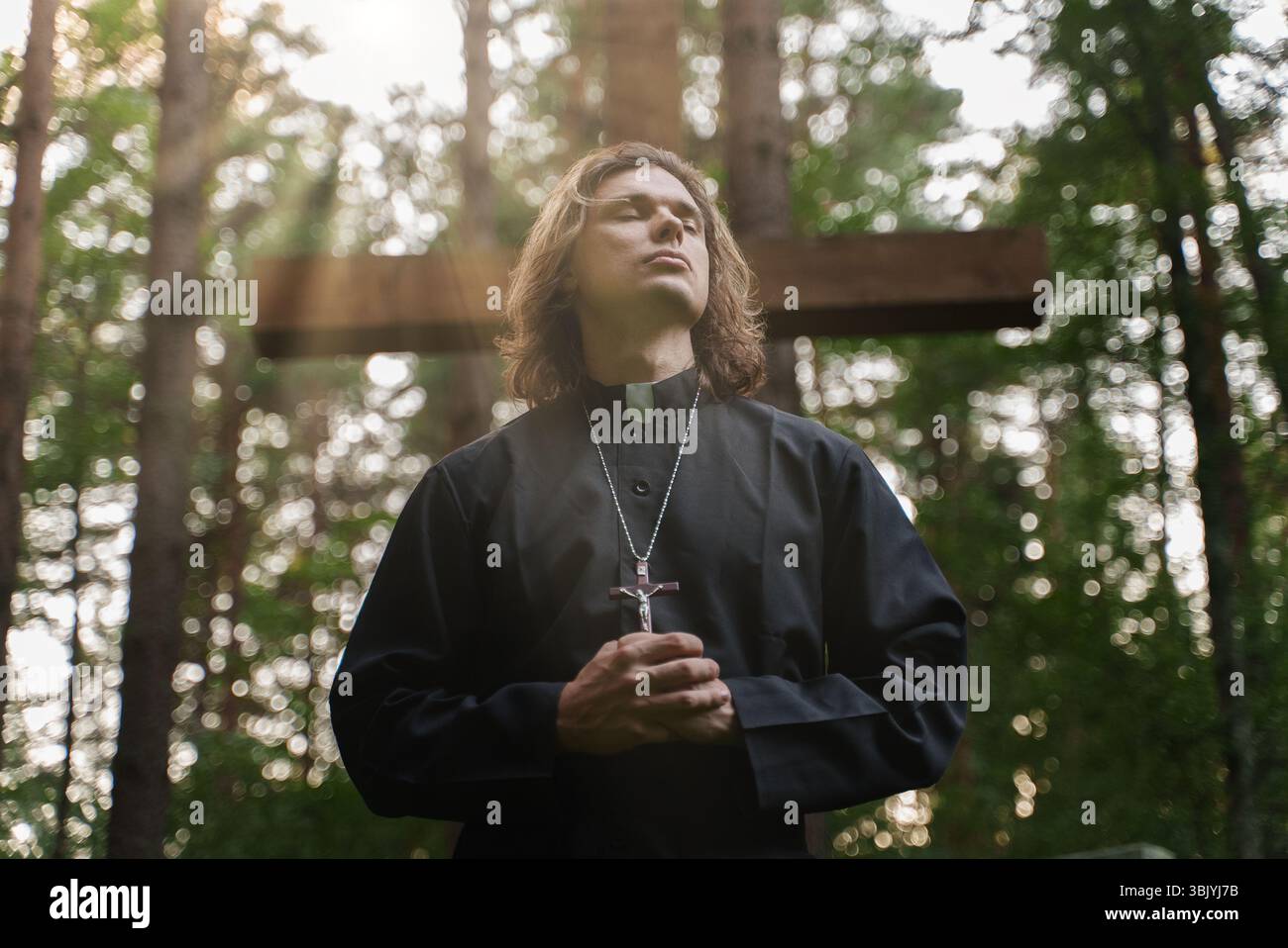 Christian priest with cross praying on the cemetery Stock Photo - Alamy