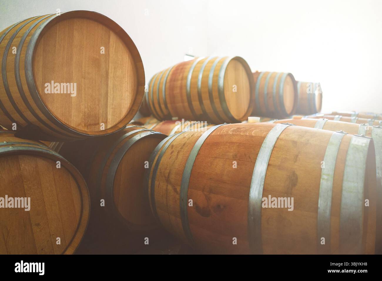 Wine barrels stacked in the cellar Stock Photo - Alamy