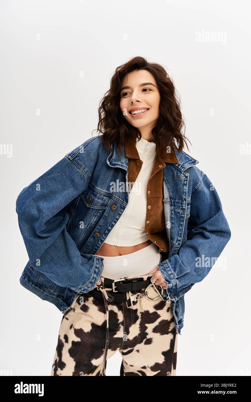 A young woman confidently poses in a chic cow print ensemble against a ...
