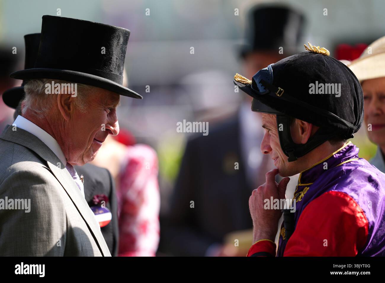 King Charles III speaks to Ryan Moore ahead of the Ascot Stakes during ...