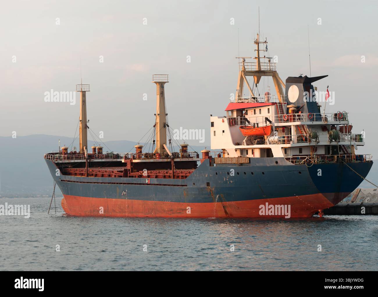 Cargo ship sailing sunset hi-res stock photography and images - Alamy