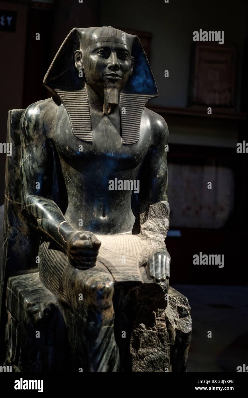 Cairo, Egypt - September 9, 2023: Majestic ancient Egyptian pharaoh statue seated on throne with ...