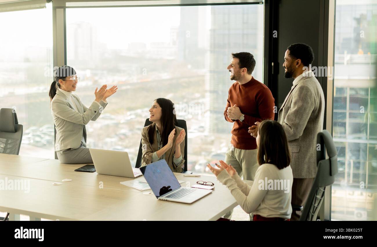 A group of professionals actively discusses project plans in a ...
