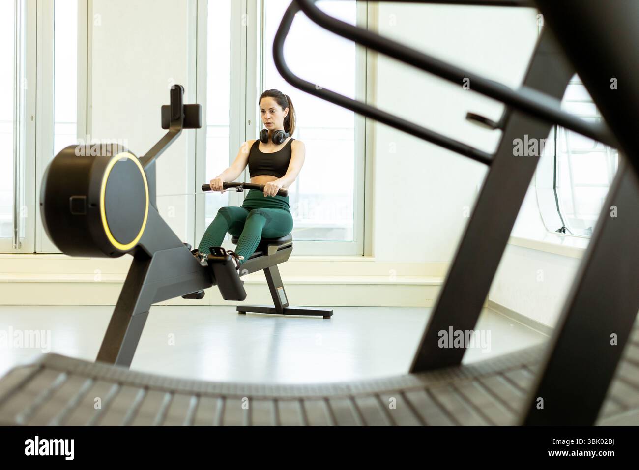 A dedicated athlete engages in a rowing workout, showcasing commitment ...